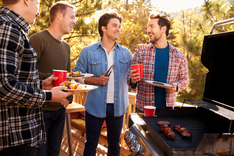 Group Of Male Friends Enjoying Barbeque Together - Footprints Resort